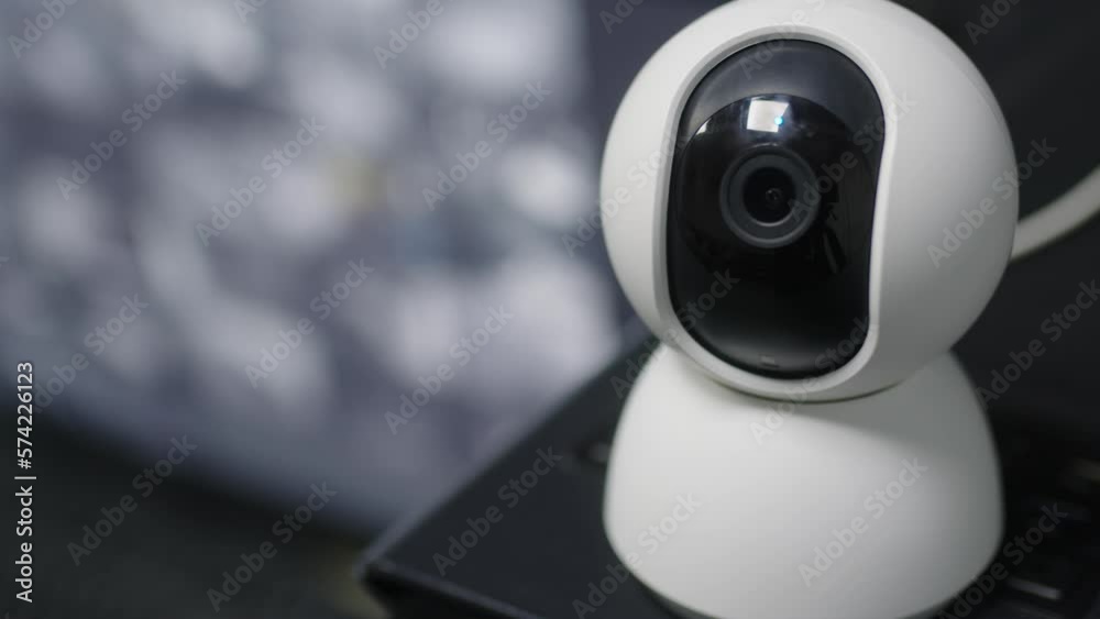 Security video camera moving to scan the area for surveillance purposes ...