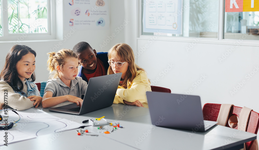 Foto de Group of school kids learn to code and program robots in a ...