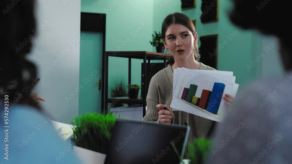 Caucasian beautiful lady explaining the graphics, showing analysis to ...