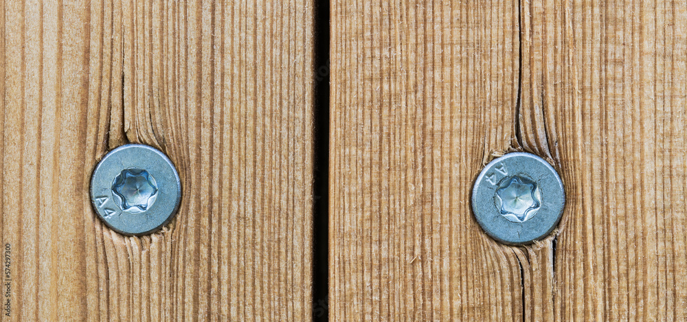 Stainless steel self-tapping wood screws in a wall of natural larch ...