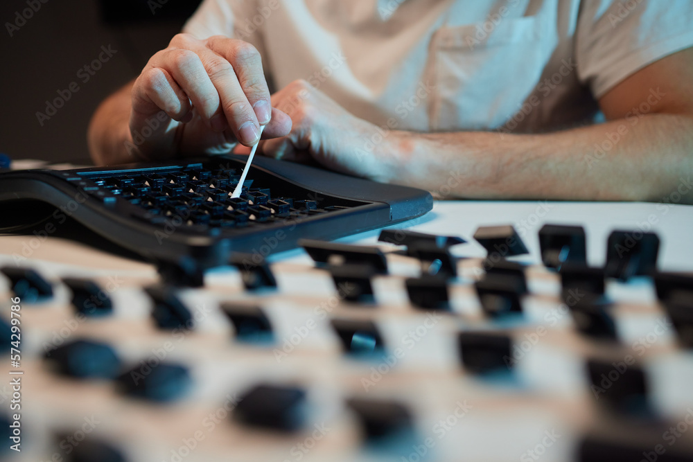 Old dirty computer keyboard with removed keys. The tools for repair and ...