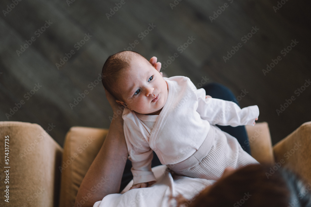 Portrait of happy mum holding infant child on hands. Loving mom carying ...