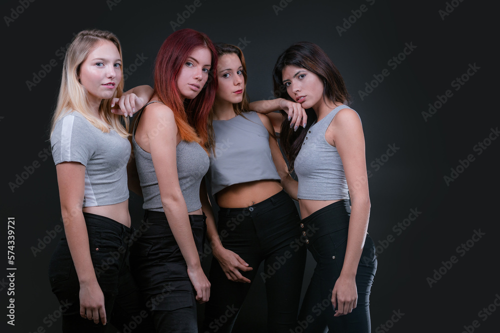 Group of young female fashion models posing on camera. Young beautiful ...