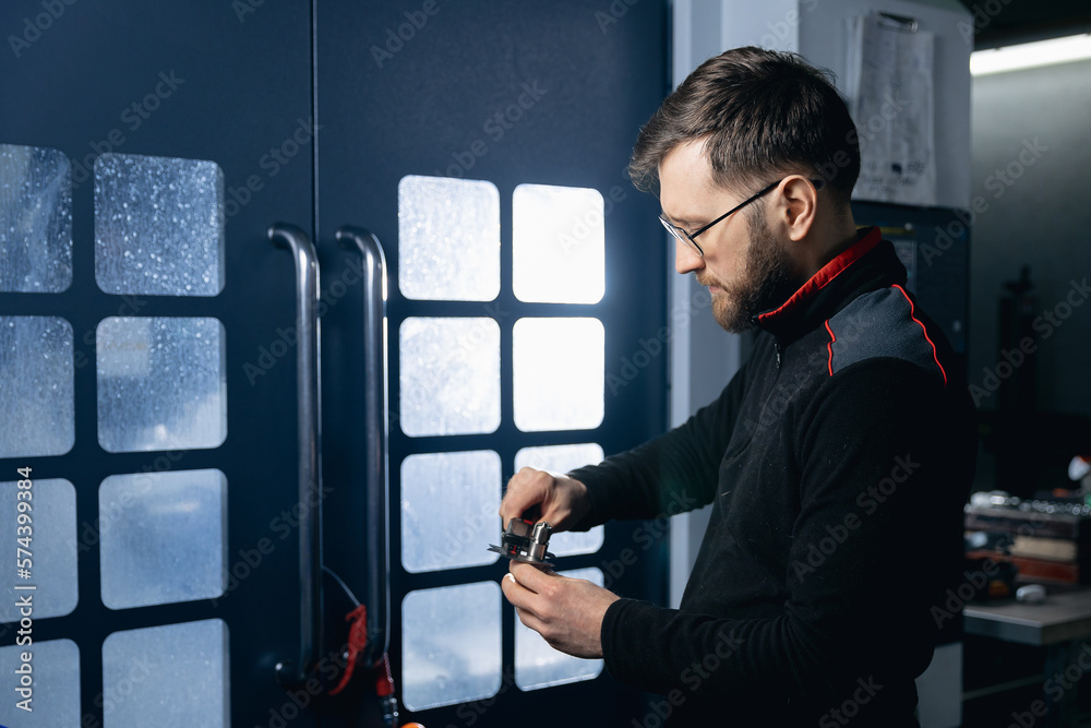 Man engineer takes dimensions from a part after Working CNC turning ...