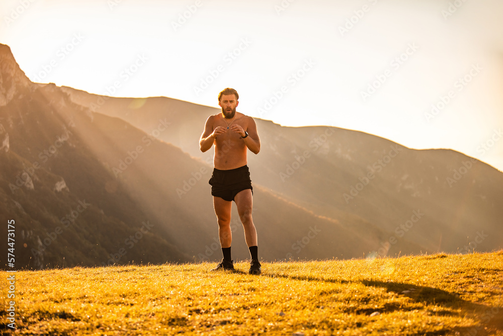 Man boxing with shadow exercising at sunset outdoor. Port victory ...