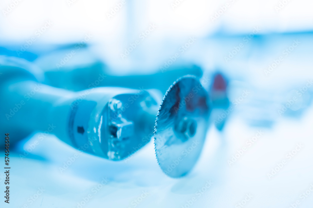 Blue tone color selective focus of medical saw with blur background ...