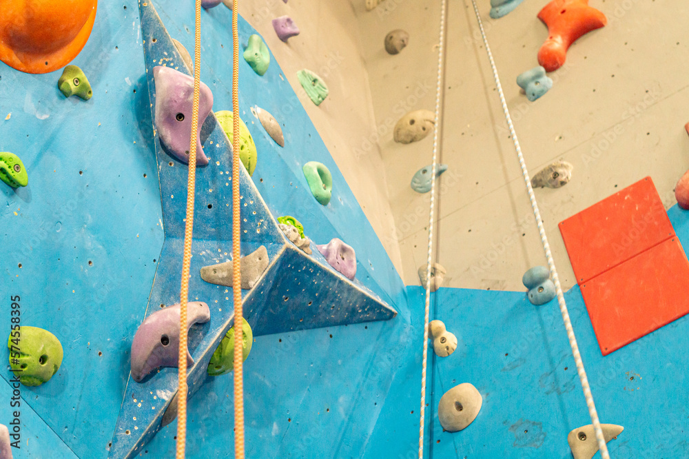 Multi-colored bright high walls of the climbing wall / Interior of a ...