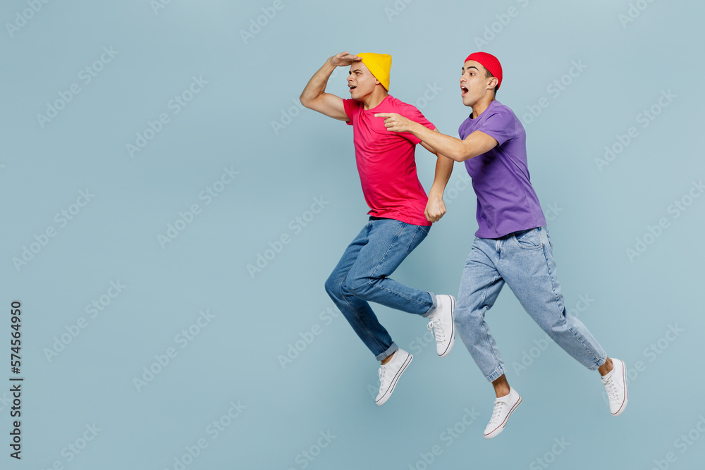 Full body sideways profile fun young couple two friends men wear casual ...