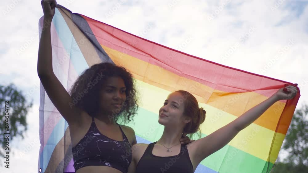 Portrait of fit healthy multi ethnic couple of women, people with LGBT ...