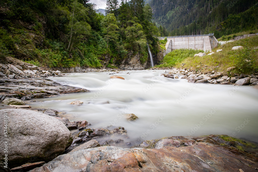 river curve with rocks in the foreground hydroelectric power station in ...