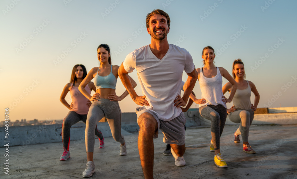 Group of happy fit people friends exercising together outdoor to stay ...