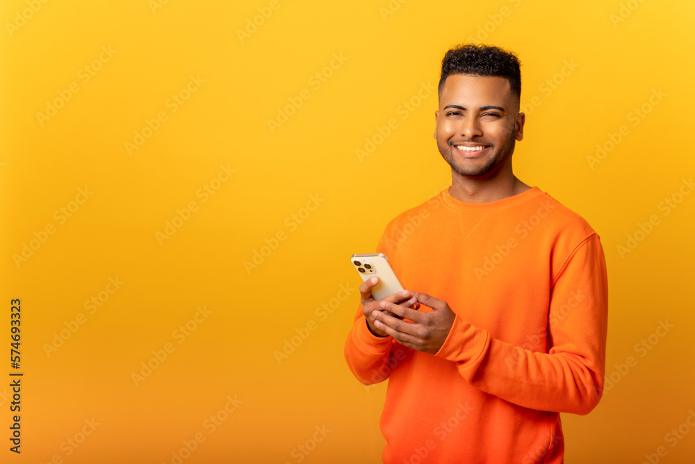 Photo Of Handsome Cheerful Smiling Man Holding Mobile Phone In The Hand