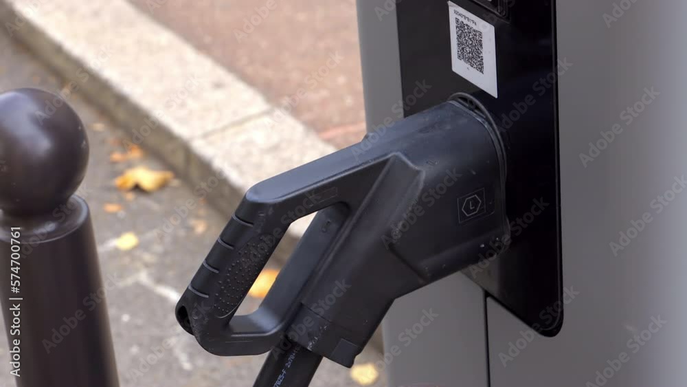 cable plugged to a socket outlet at a charging station for electric ...