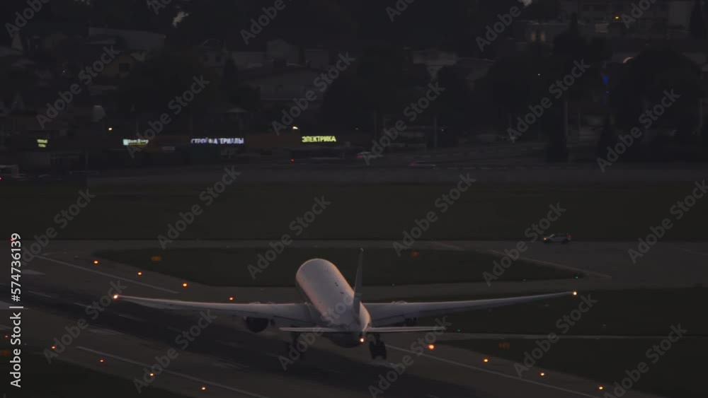 Looking at ascending airplane from the ground. Rear view of flying ...