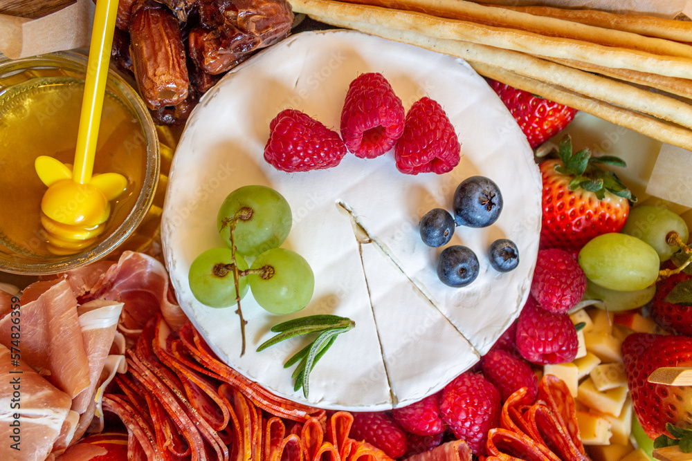 high angle close up view from above of brie with fruit on top on a ...