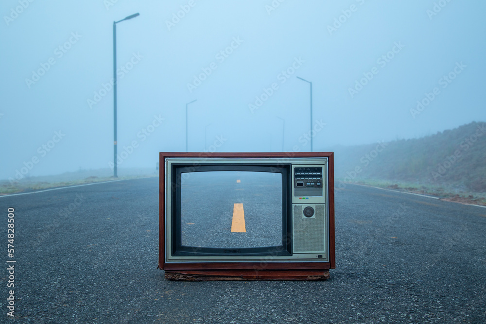 Retro classic old TV frame on asphalt road with fog in winter, close up ...