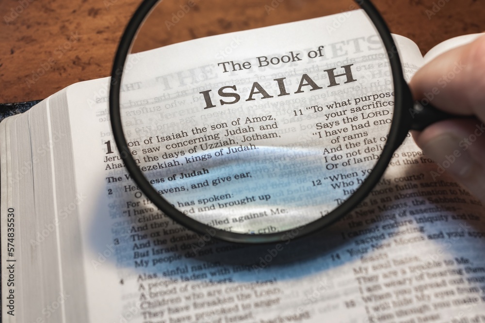 title page book of Isaiah close up using magnifying glass in the bible ...
