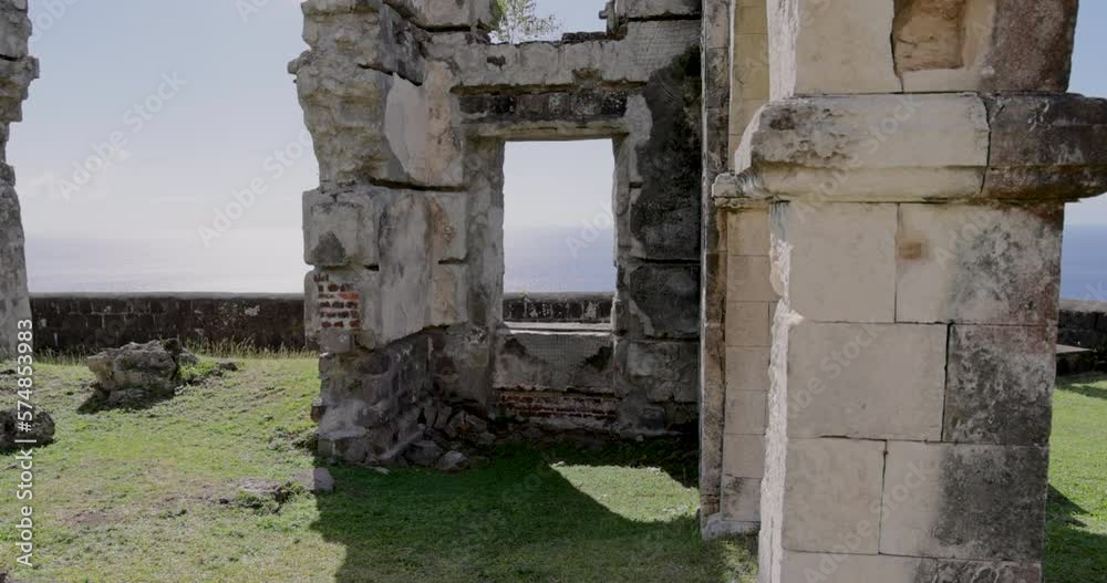 Window looks out to sea over the Caribbean Ocean in ruins of a wall in ...