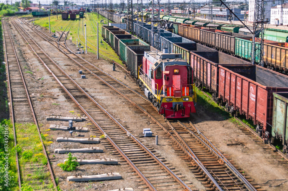 Shunting diesel locomotive and railway wagons. Railway wagons at the ...