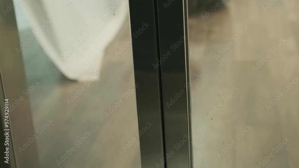 shopping mall, doors of the glass elevator opening. view through glass ...