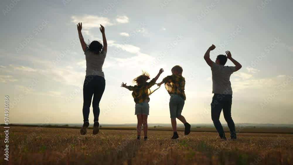happy family jumping. father mother and kids together jump in park at ...