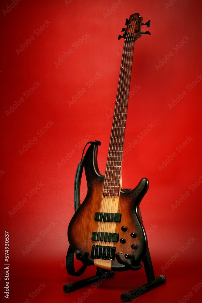 Full scales 5 strings bass guitar at stand with natural finish ...