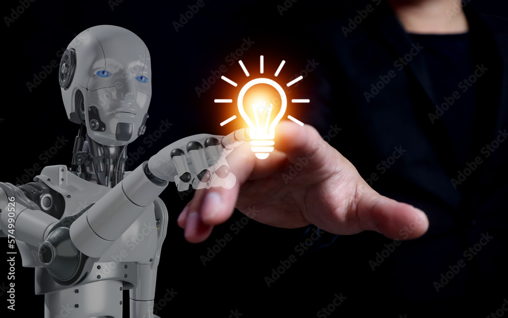 Smart business man and robot Using your finger to touch the light bulb ...