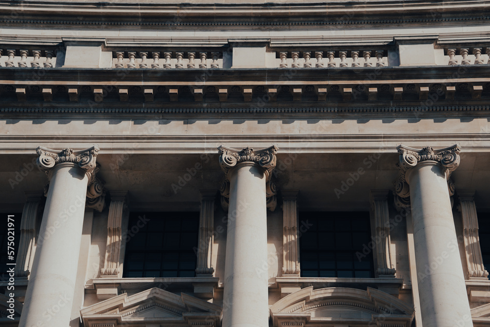Roman style columns supporting a building in the sun, three pillars ...