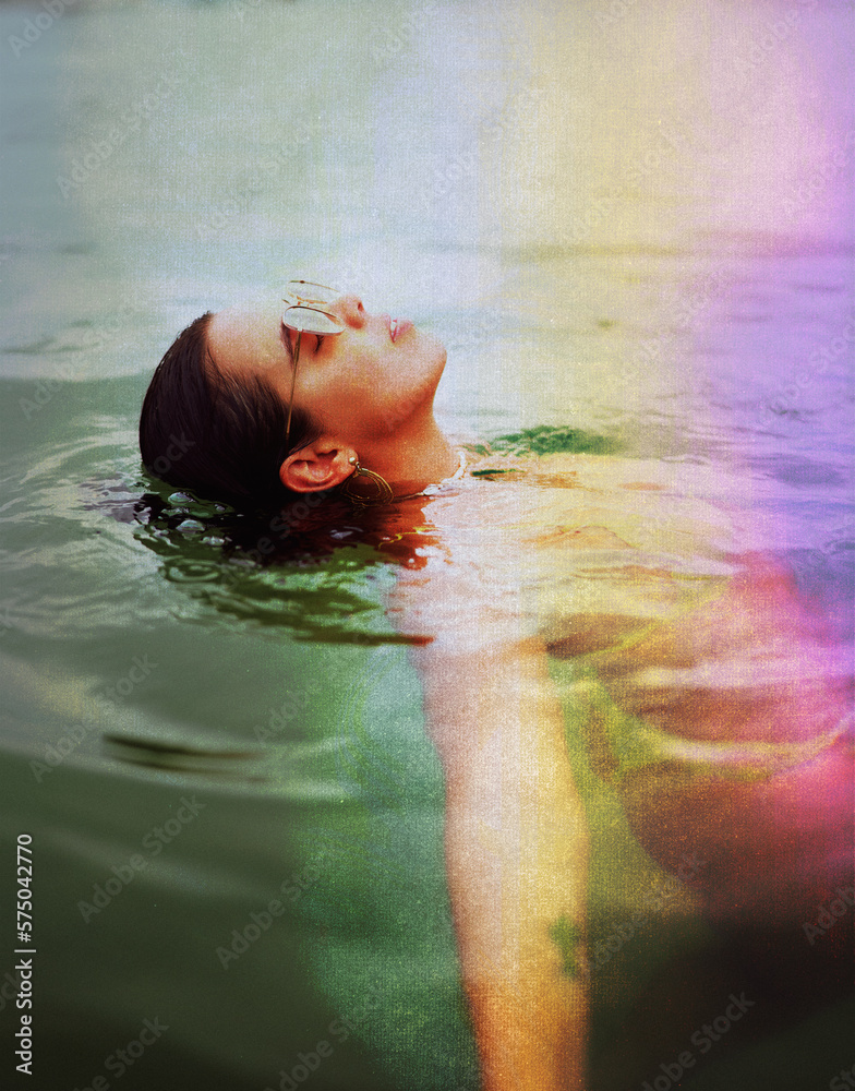 young brazilian woman floating or swimming in the water relaxed with ...