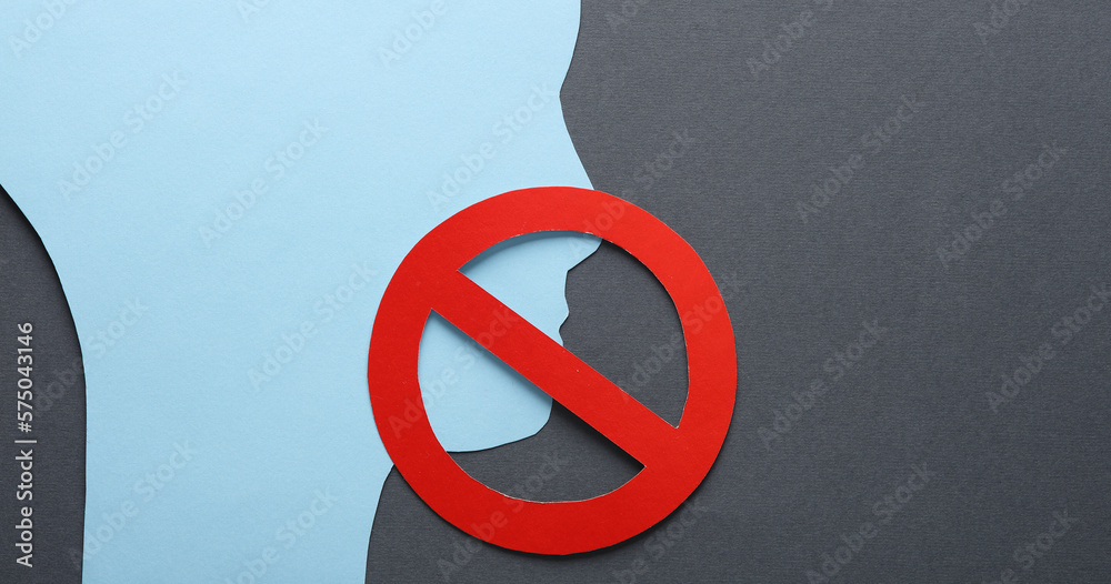 Paper cut face silhouette with prohibition sign on gray background ...