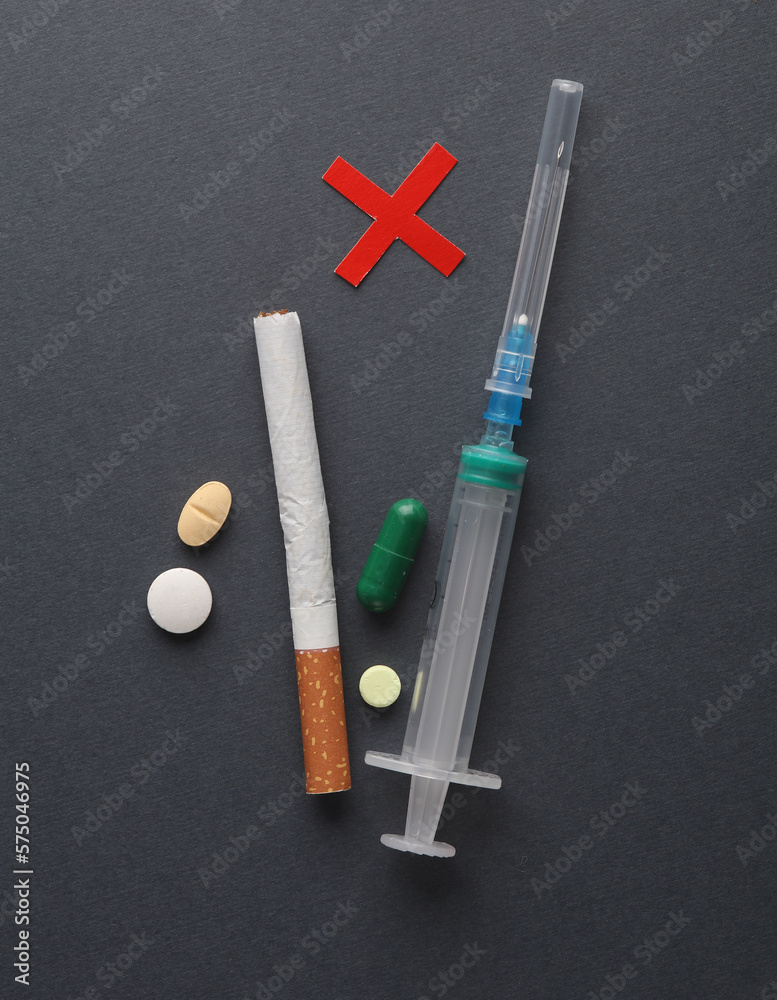 Let's stop drug addiction. Pill syringe and cigarette with prohibition ...