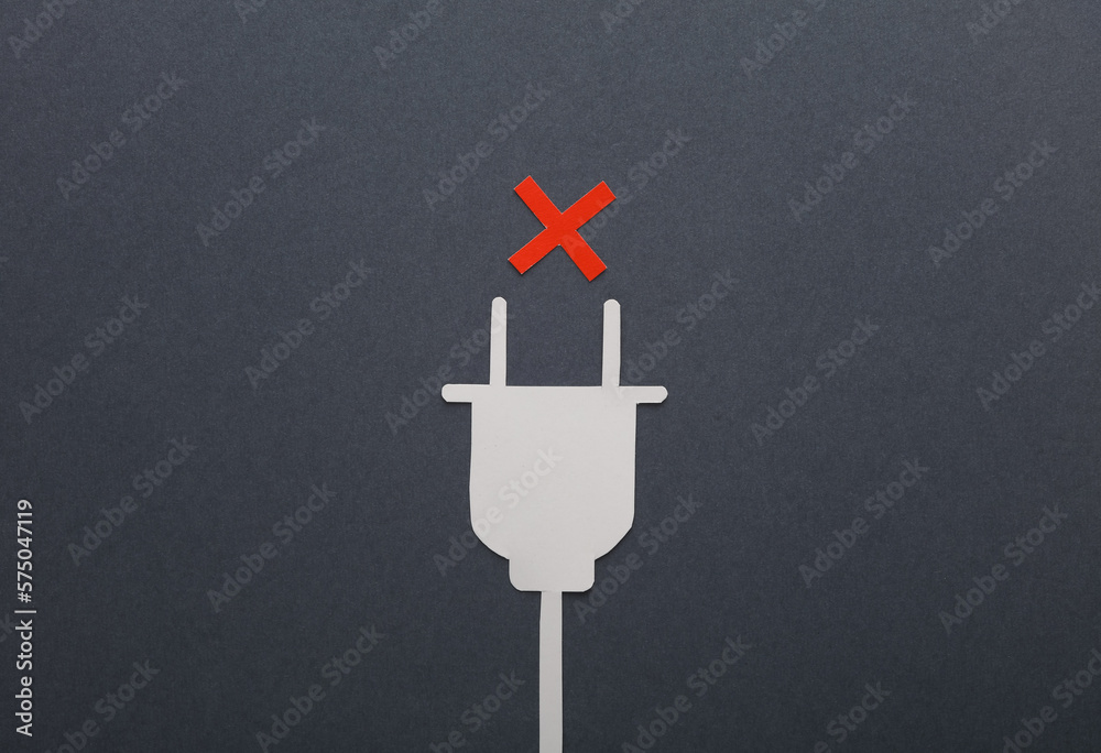 Electrical plug with a cross prohibition sign on a dark background ...