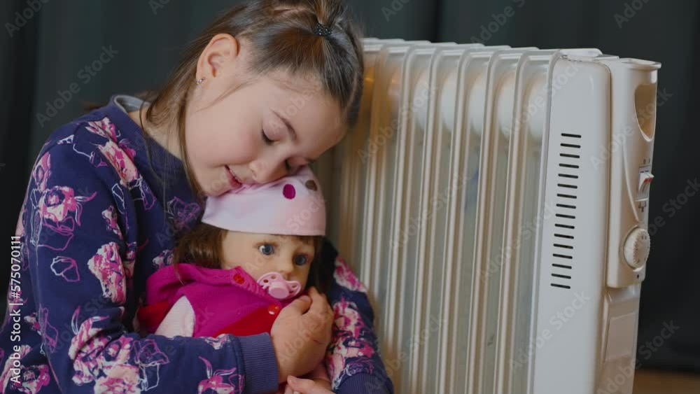 Video Stock Little girl hugging doll toy to warming near European style ...