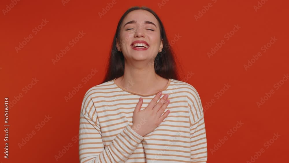 Amused pretty woman pointing finger to camera, laughing out loud ...