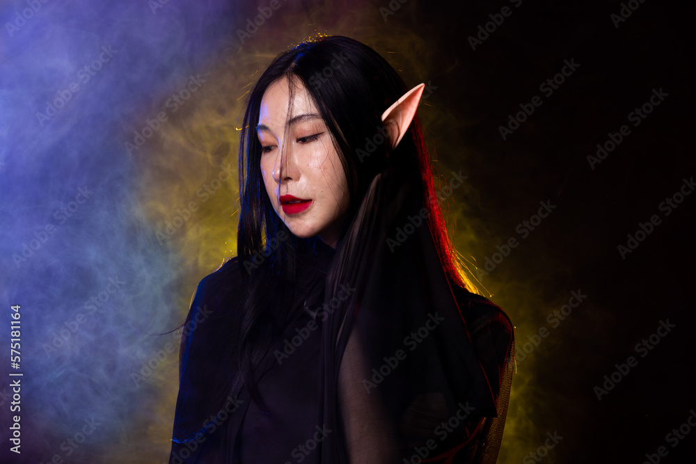 Fairy woman elf queen in black fantasy rope long dress cast spell ...