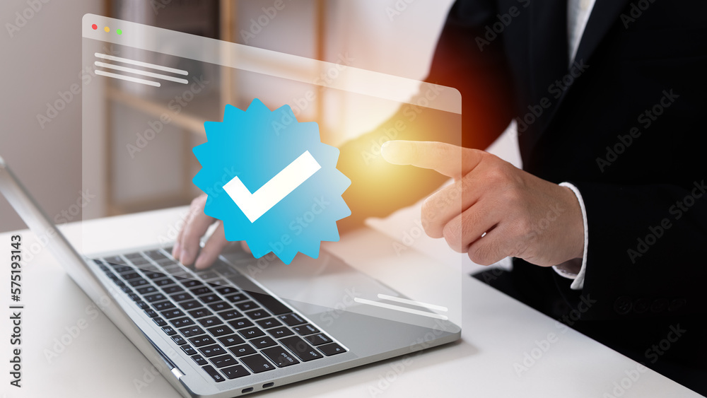 Businessman using laptop with verification account blue tick checkmark ...