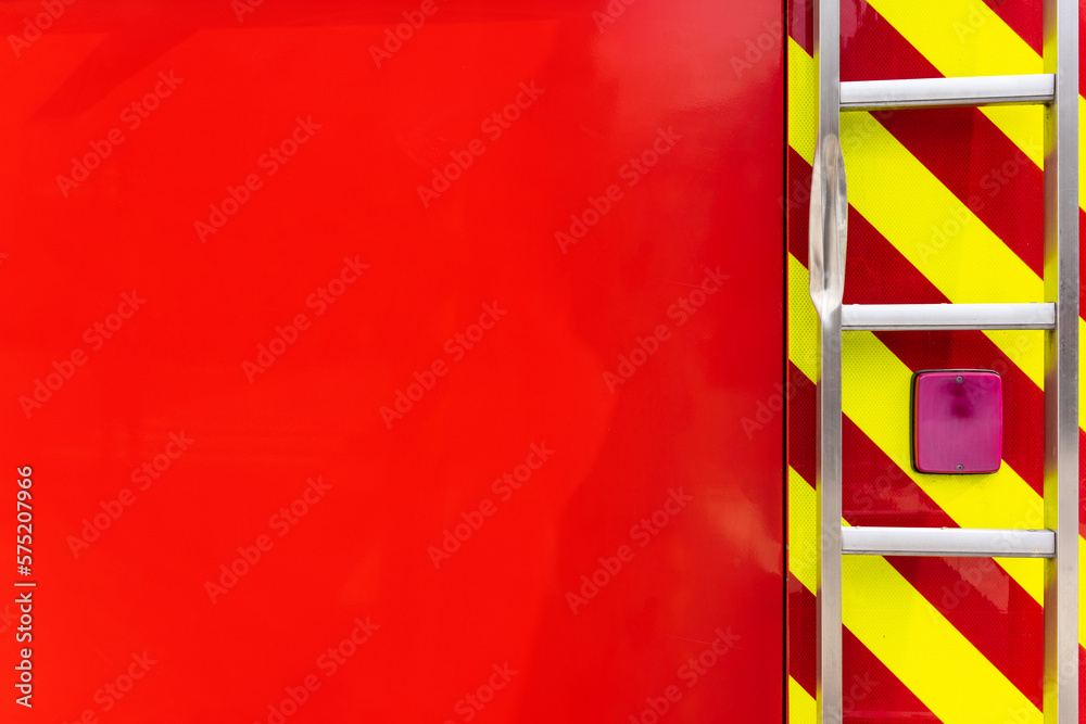Front view of a fire truck with a ladder, warning stripes and lots of ...