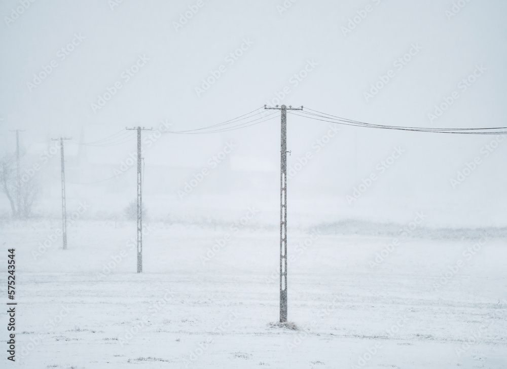 Heavy snow on electrical wires. Frozen electric wires in the city ...