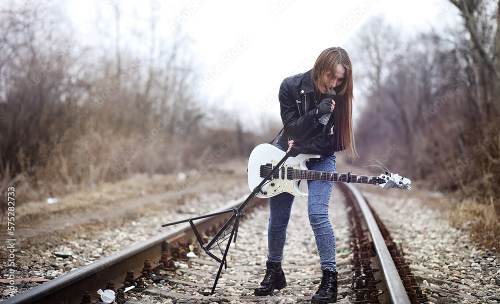 Beautiful young girl rocker with electric guitar. A rock musician girl ...