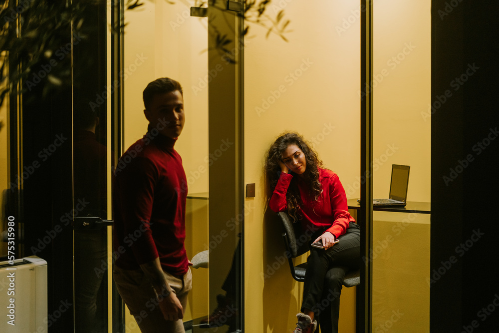 Two colleagues, male and female, ended their video call at the phone ...