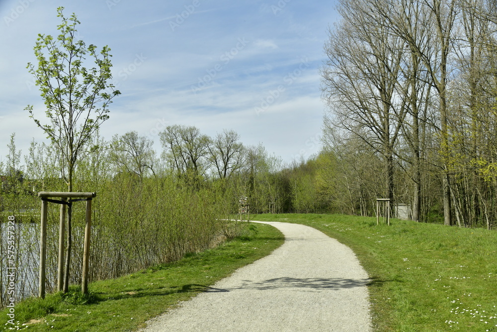 Chemin en gravier clair longeant bois et plans d'eau au parc du Paradis ...