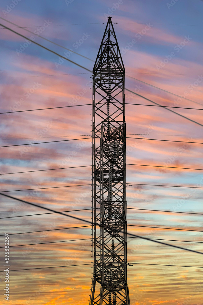 Enveloped by a maze of wires, a tower supports electric lines as part ...