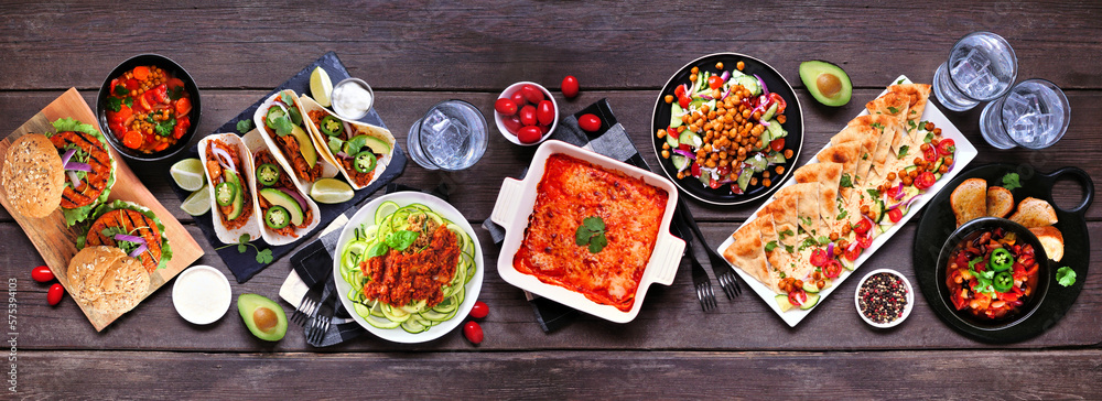 Healthy plant based vegetarian meal table scene. Above view on a dark ...