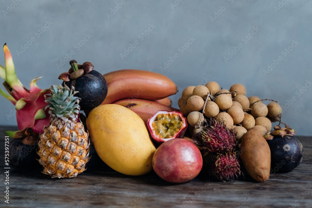Still life with asian fruits. Set of colorful fruits. Dark photo ...