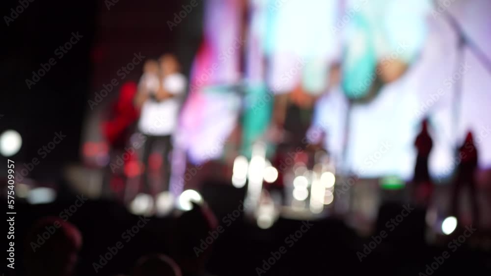Illuminated and blurry dancing crowd at a concert. Silhouette of people ...