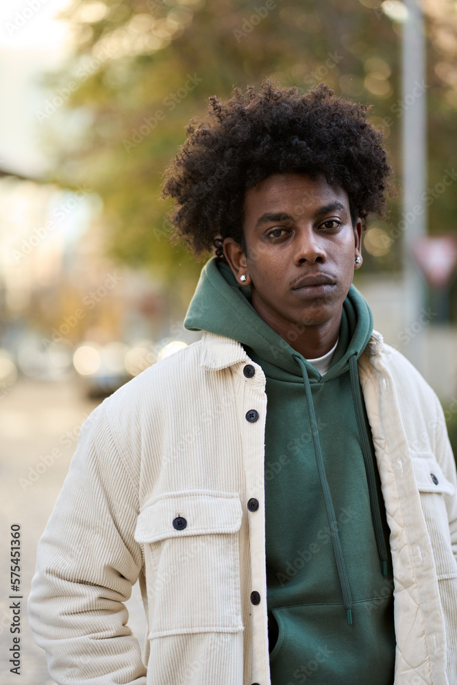 Confident cool young African American guy model standing at city street ...