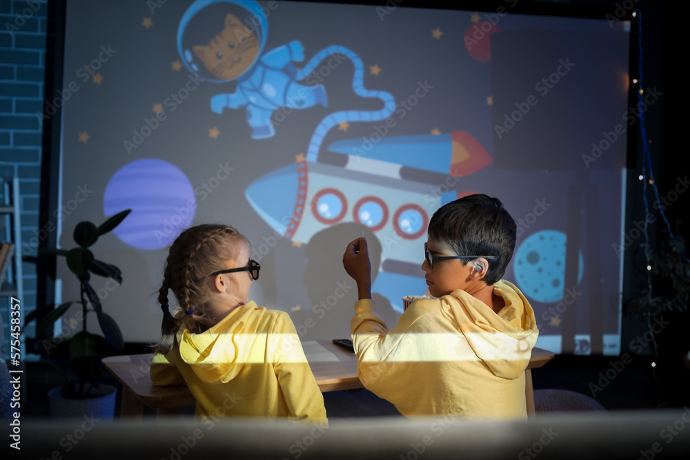 Little children in 3D glasses with popcorn watching cartoons on ...