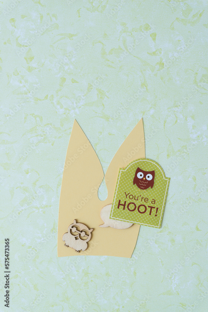 sticker with "you're a hoot!" cut paper shape on scrapbook paper Stock ...