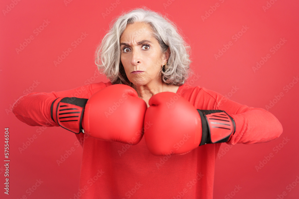 Rude mature woman in boxing gloves looking at camera Stock Photo ...