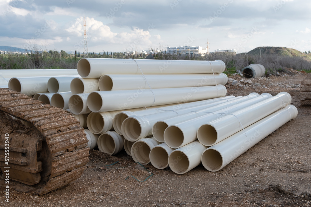 Plumbing. new PVC pipe heap, pile near the construction site for the ...